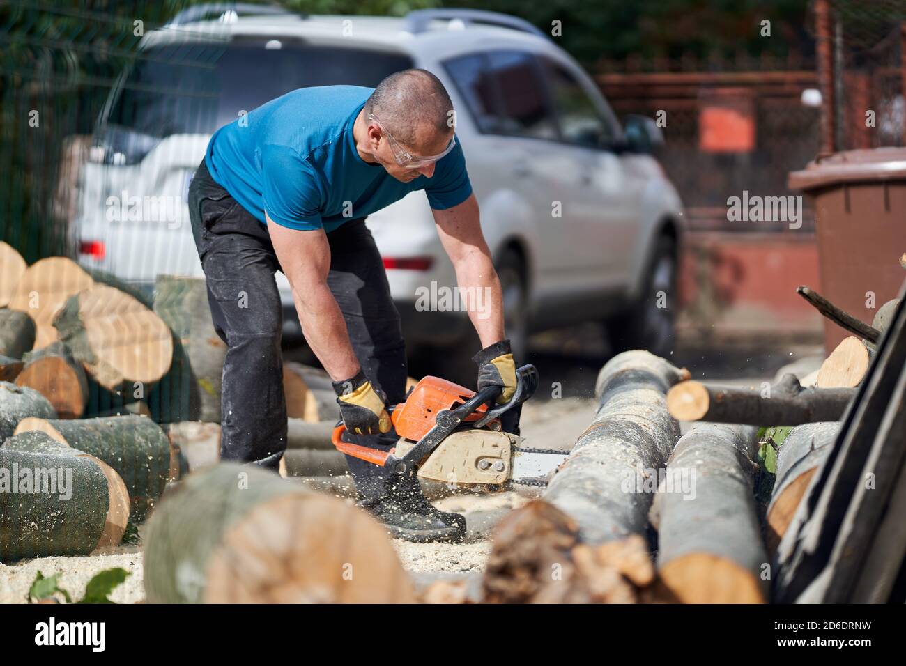 Farmer with chainsaw logging some beech wood at home Stock Photo - Alamy