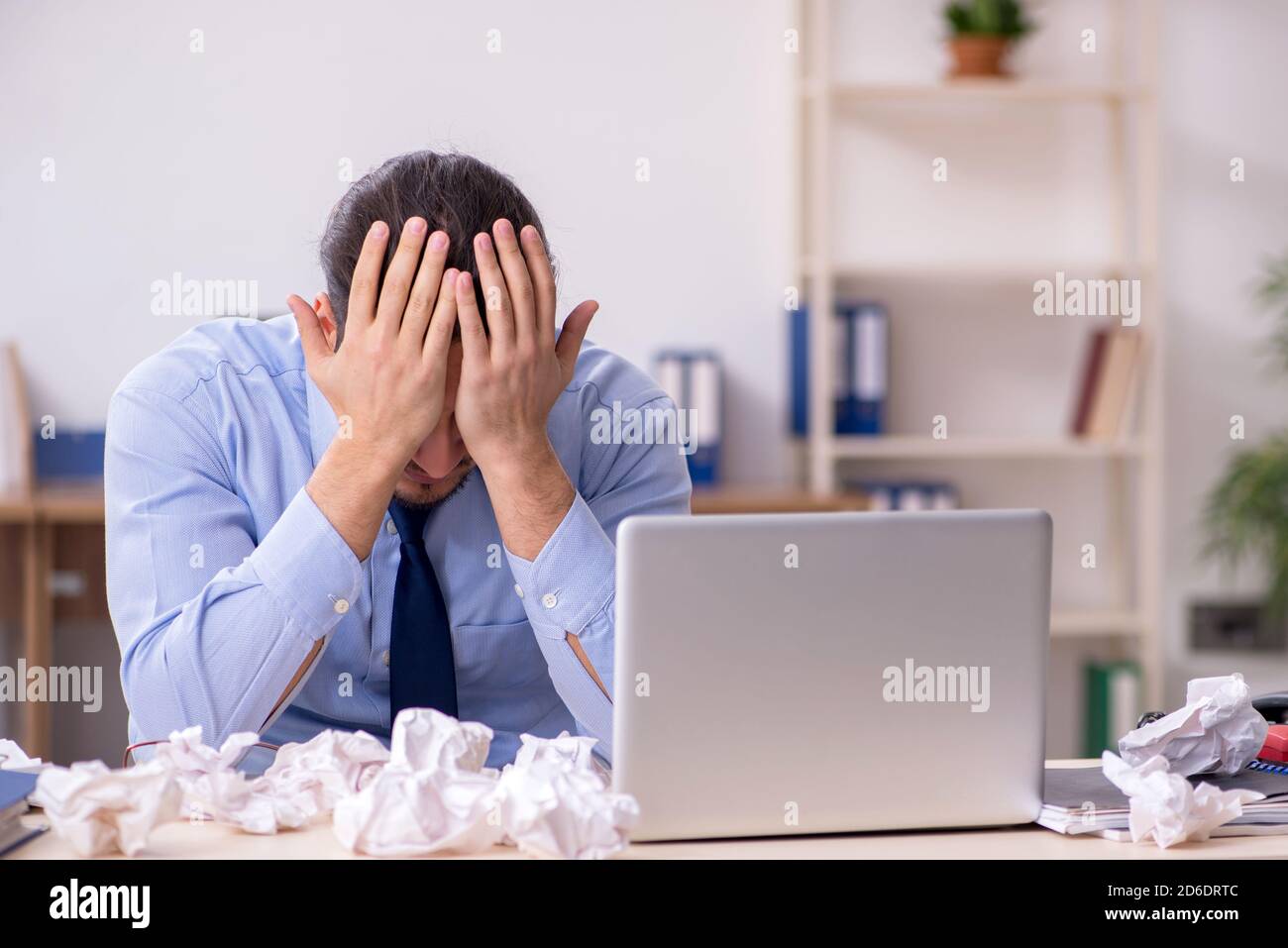 Sick male employee suffering at the workplace Stock Photo - Alamy