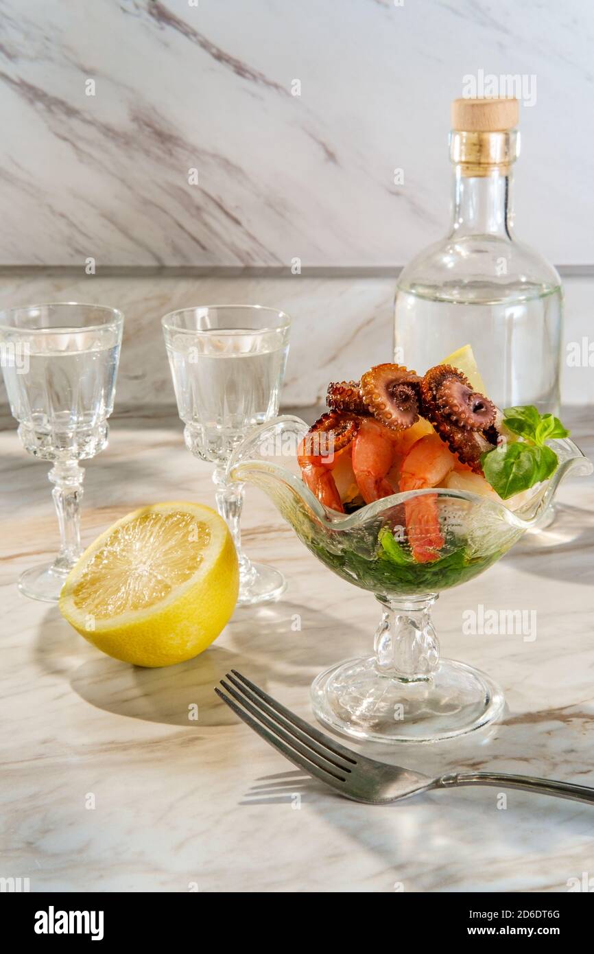 Shrimp and octopus tentacle cocktail appetizer with brunch vodka shots ...