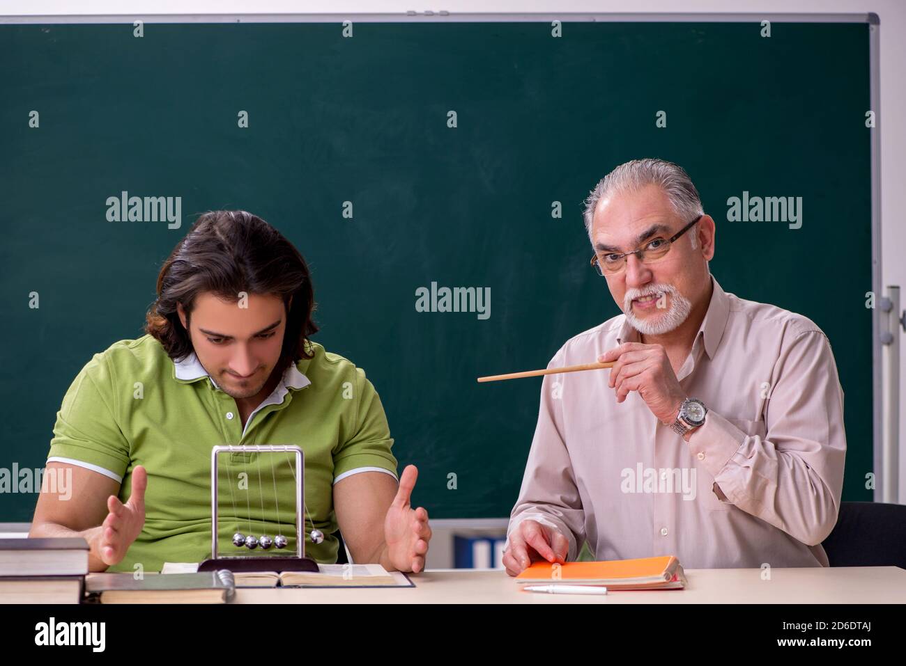 Old professor physicist and student in the classroom Stock Photo - Alamy