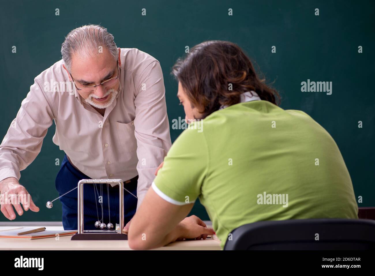 Old professor physicist and student in the classroom Stock Photo - Alamy