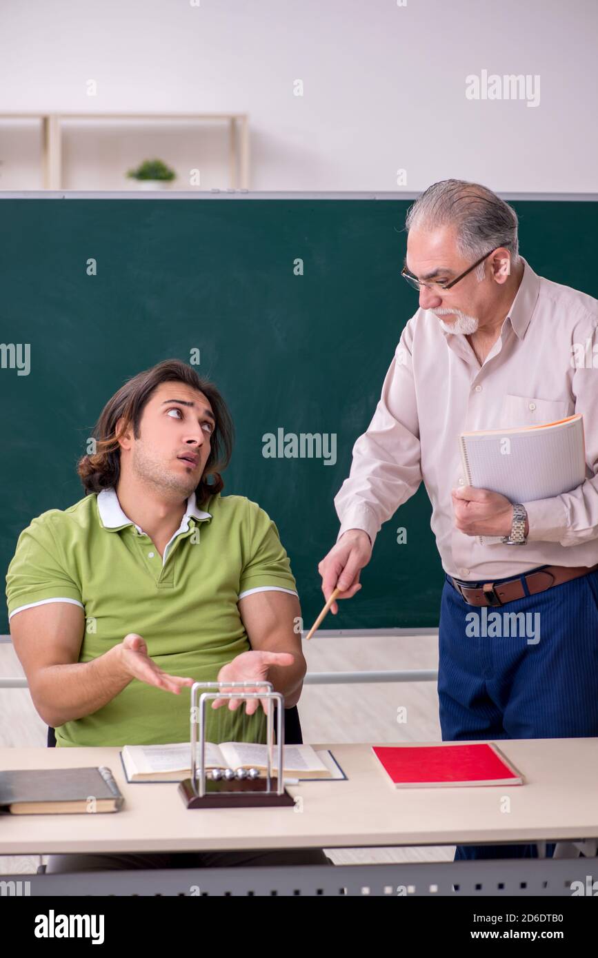 Old professor physicist and student in the classroom Stock Photo - Alamy