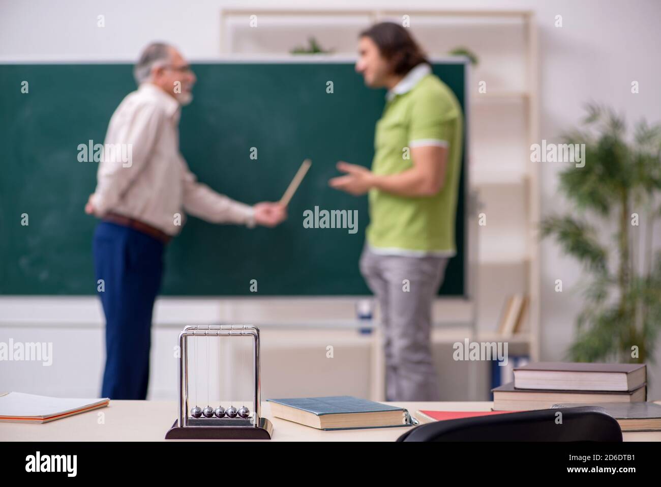 Old professor physicist and student in the classroom Stock Photo - Alamy