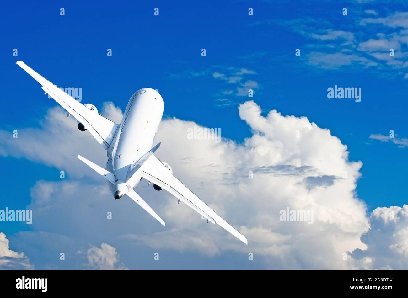 Aircraft climb flight against the background of cumulus clouds Stock ...