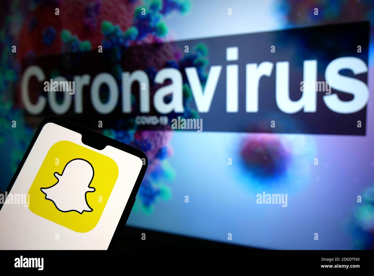 The Snapchat logo seen displayed on a mobile phone with an illustrative ...
