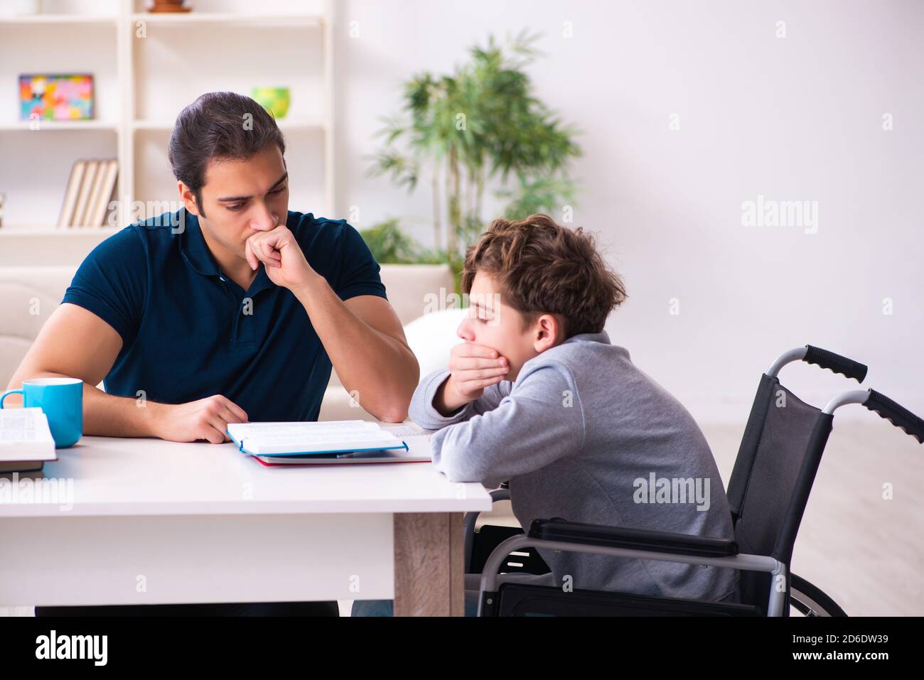 Father and disabled son in the education concept Stock Photo - Alamy
