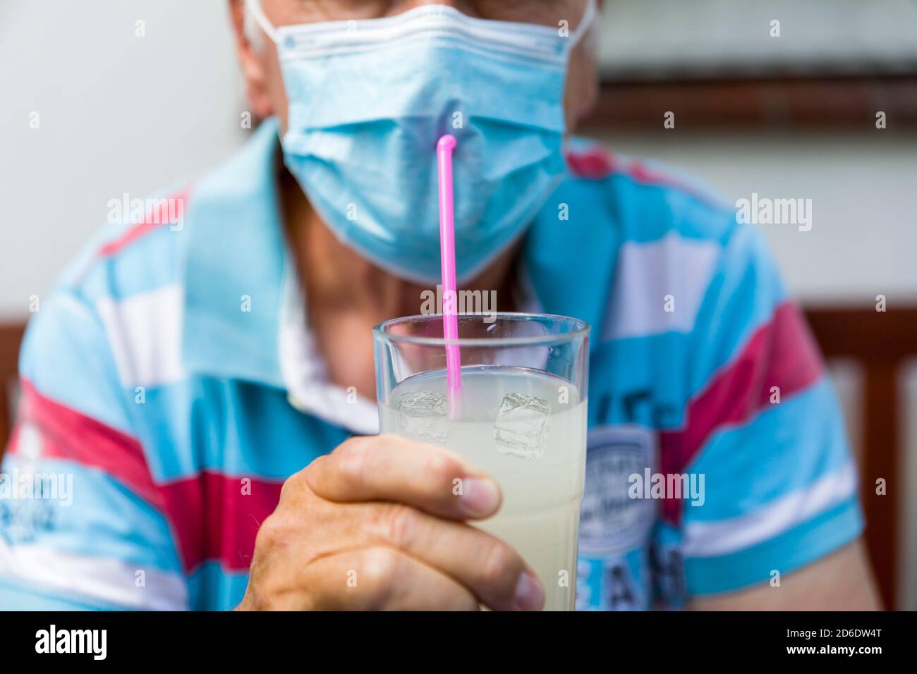 Drinking through mask hi-res stock photography and images - Alamy
