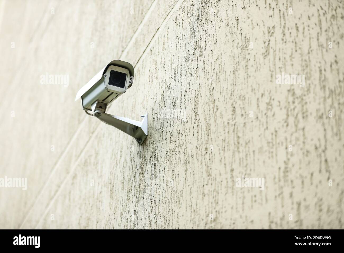 Surveillance camera on a building wall Stock Photo - Alamy