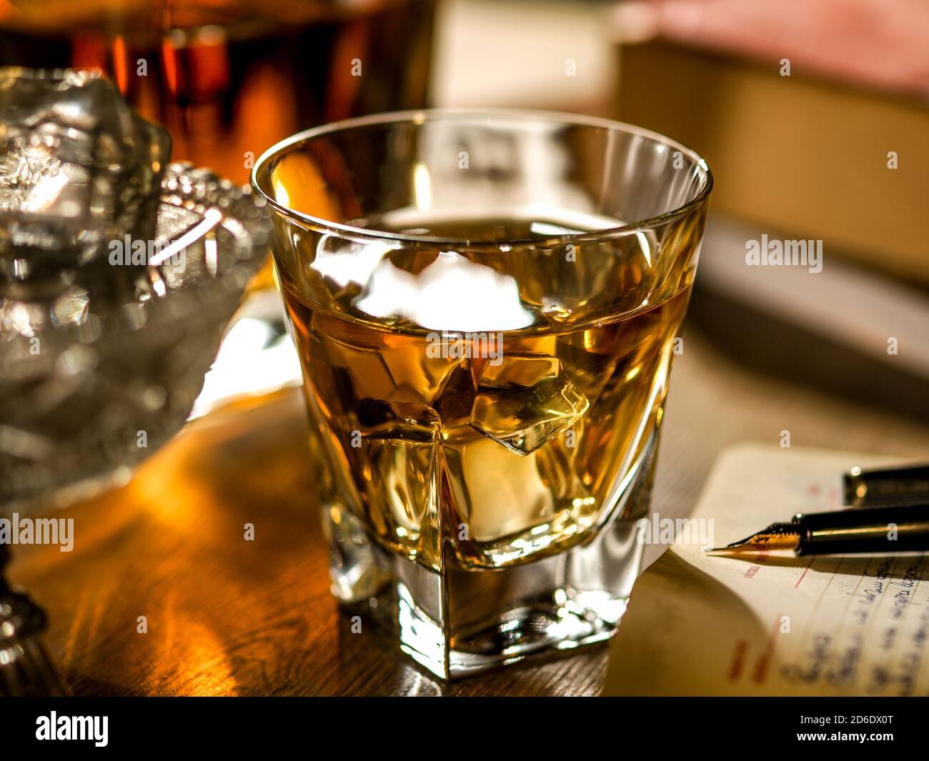 Glass of whisky, books and diary late at night Stock Photo - Alamy