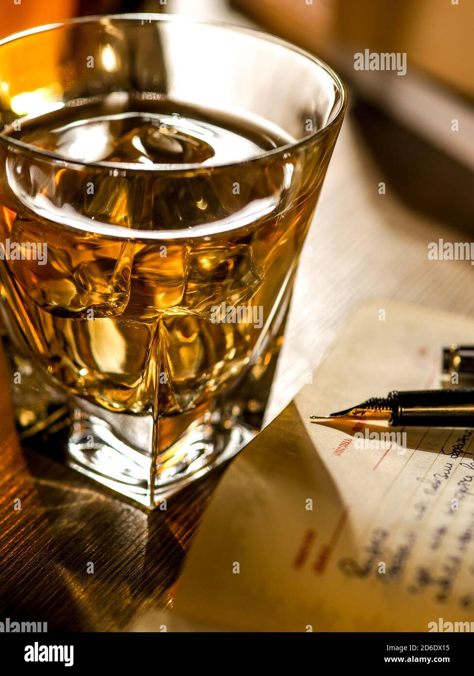 Glass of whisky, books and diary late at night Stock Photo - Alamy