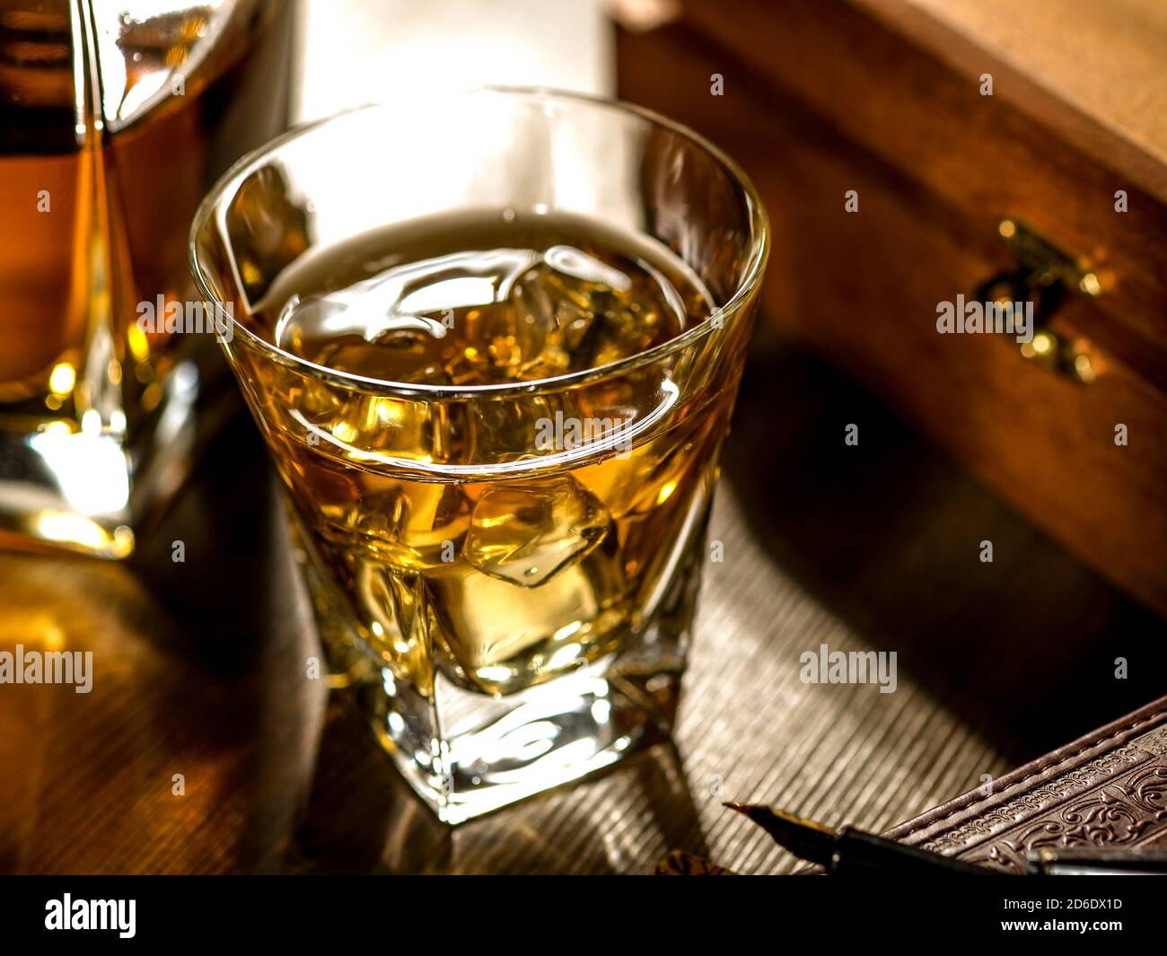 Glass of whisky, books and diary late at night Stock Photo - Alamy