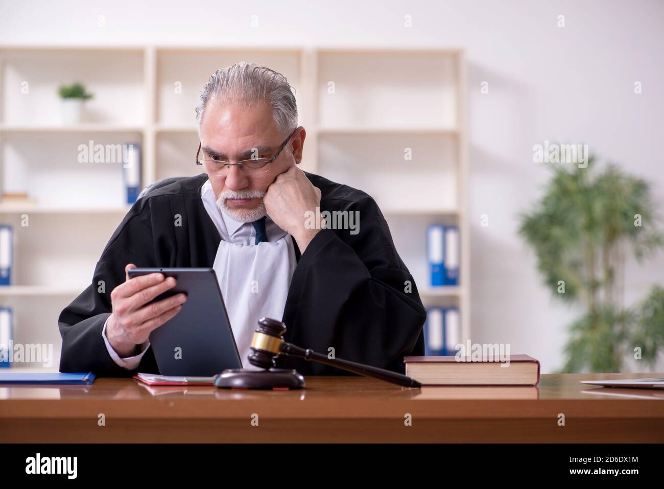 Old judge working in courthouse Stock Photo - Alamy