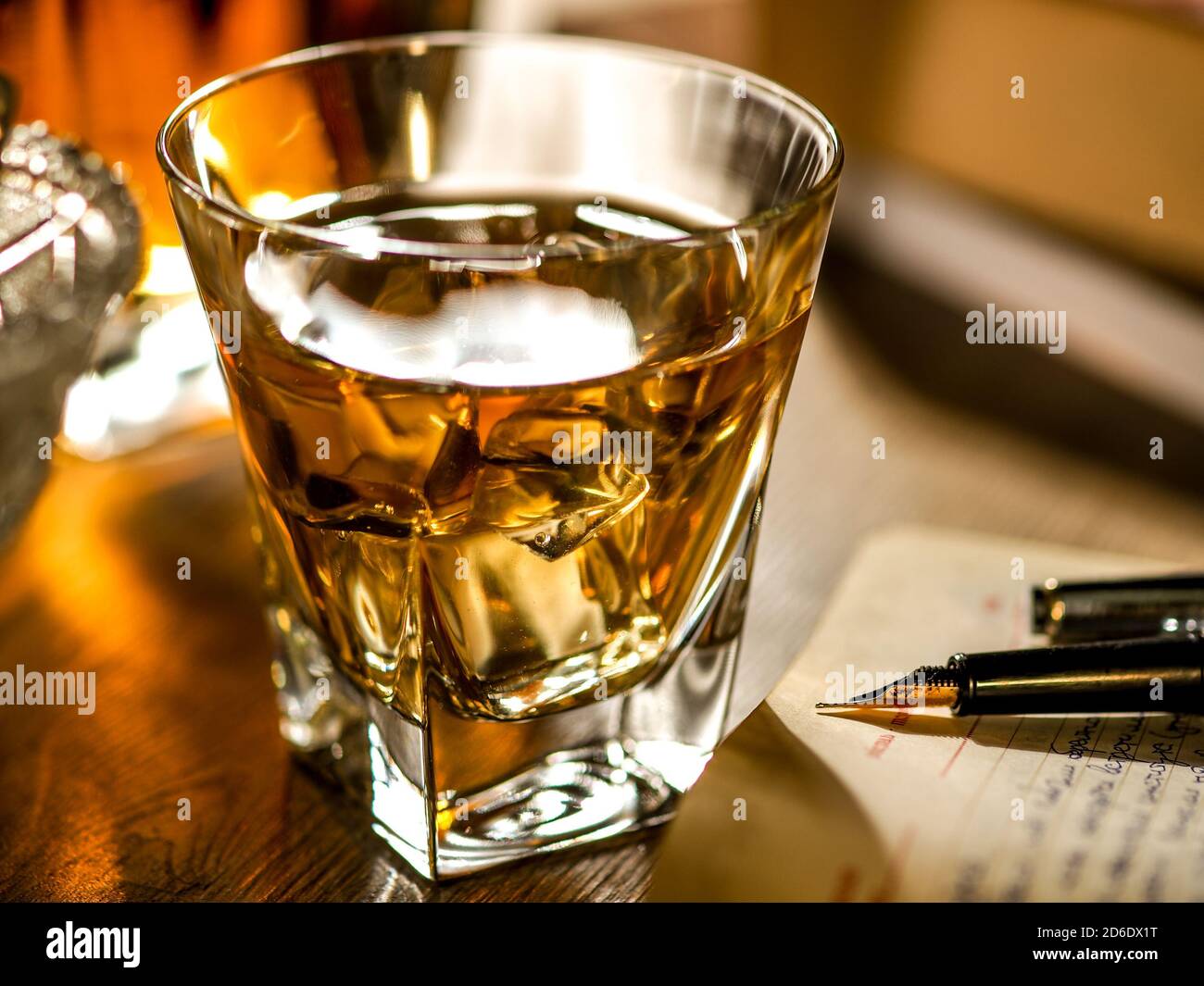 Glass of whisky, books and diary late at night Stock Photo - Alamy