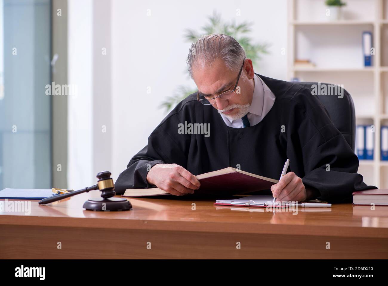 Old male judge working in the courthouse Stock Photo - Alamy