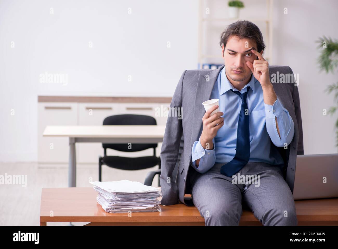 Young employee sleeping in the office Stock Photo - Alamy