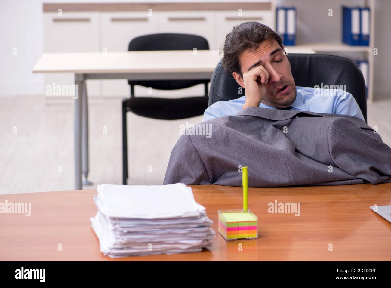 Young employee sleeping in the office Stock Photo - Alamy