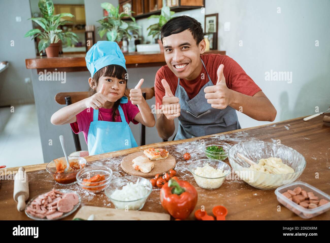 Dad and daughter making pizza dough hi-res stock photography and images ...