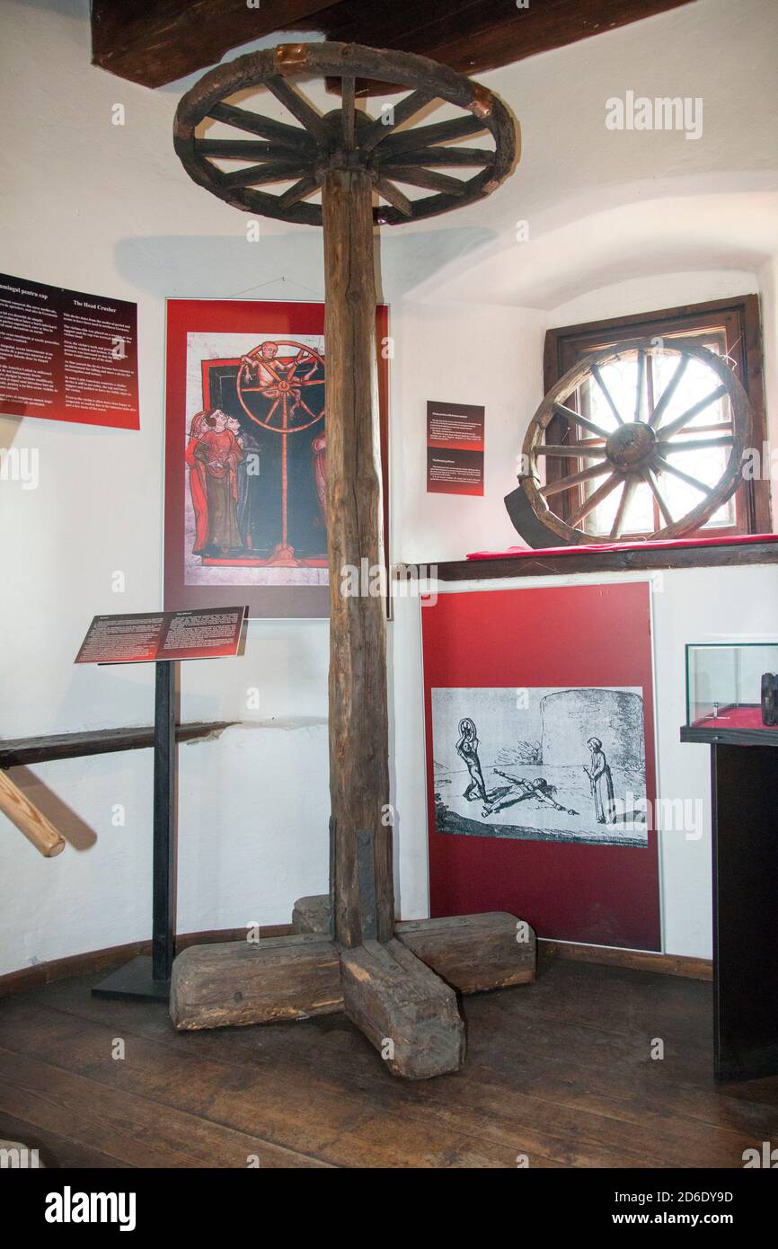 Torture breaking wheel. The executioners beat the victim on the device ...