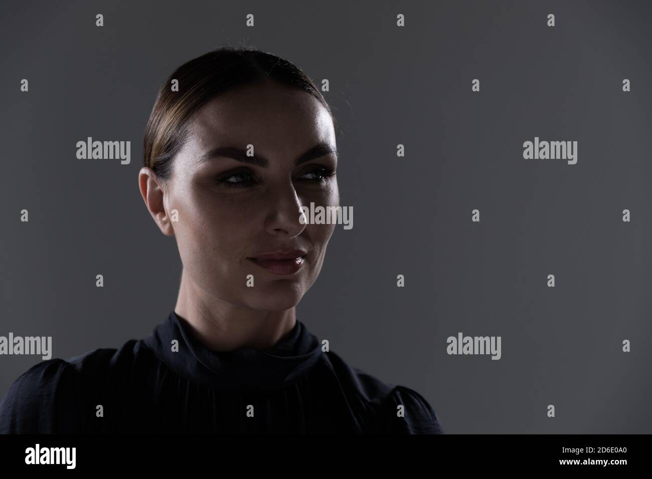Young woman against grey background Stock Photo - Alamy