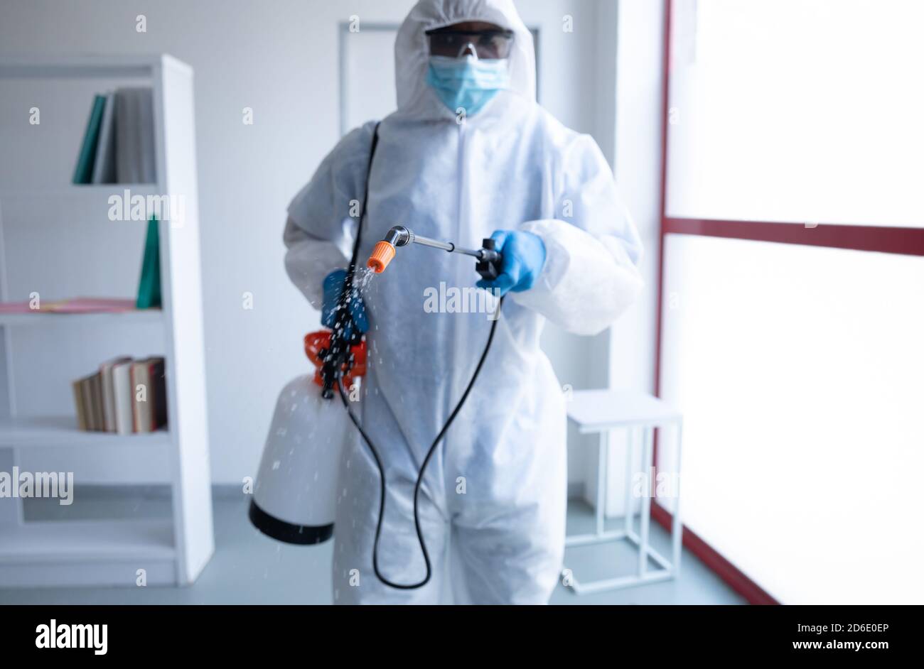 Health worker wearing protective clothes cleaning using disinfectant ...