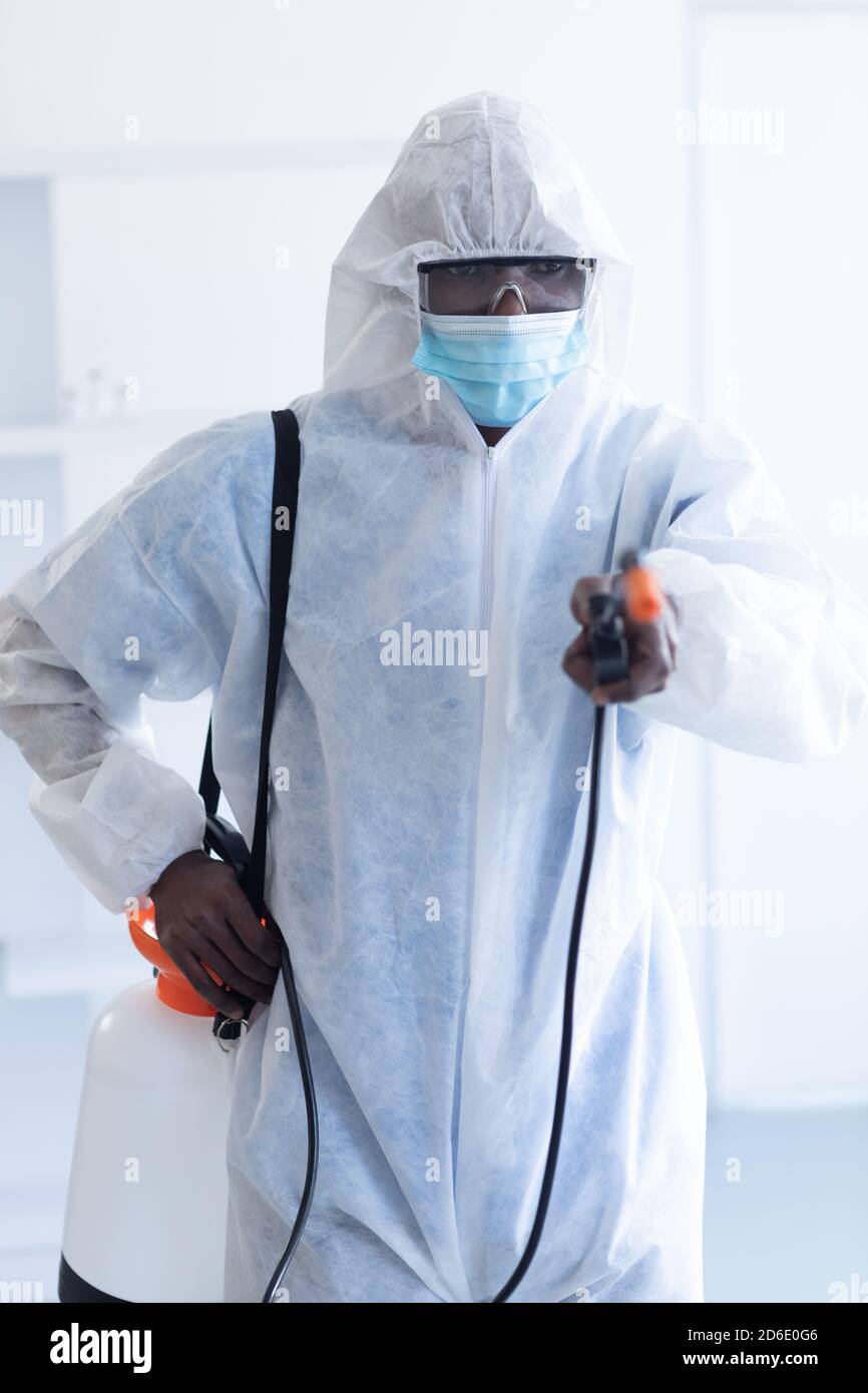 Health worker wearing protective clothes cleaning using disinfectant ...
