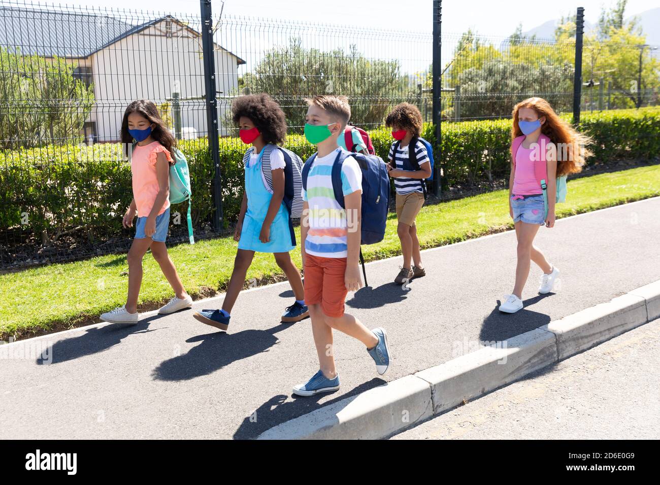 Group of kids wearing face masks walking on footpath Stock Photo - Alamy