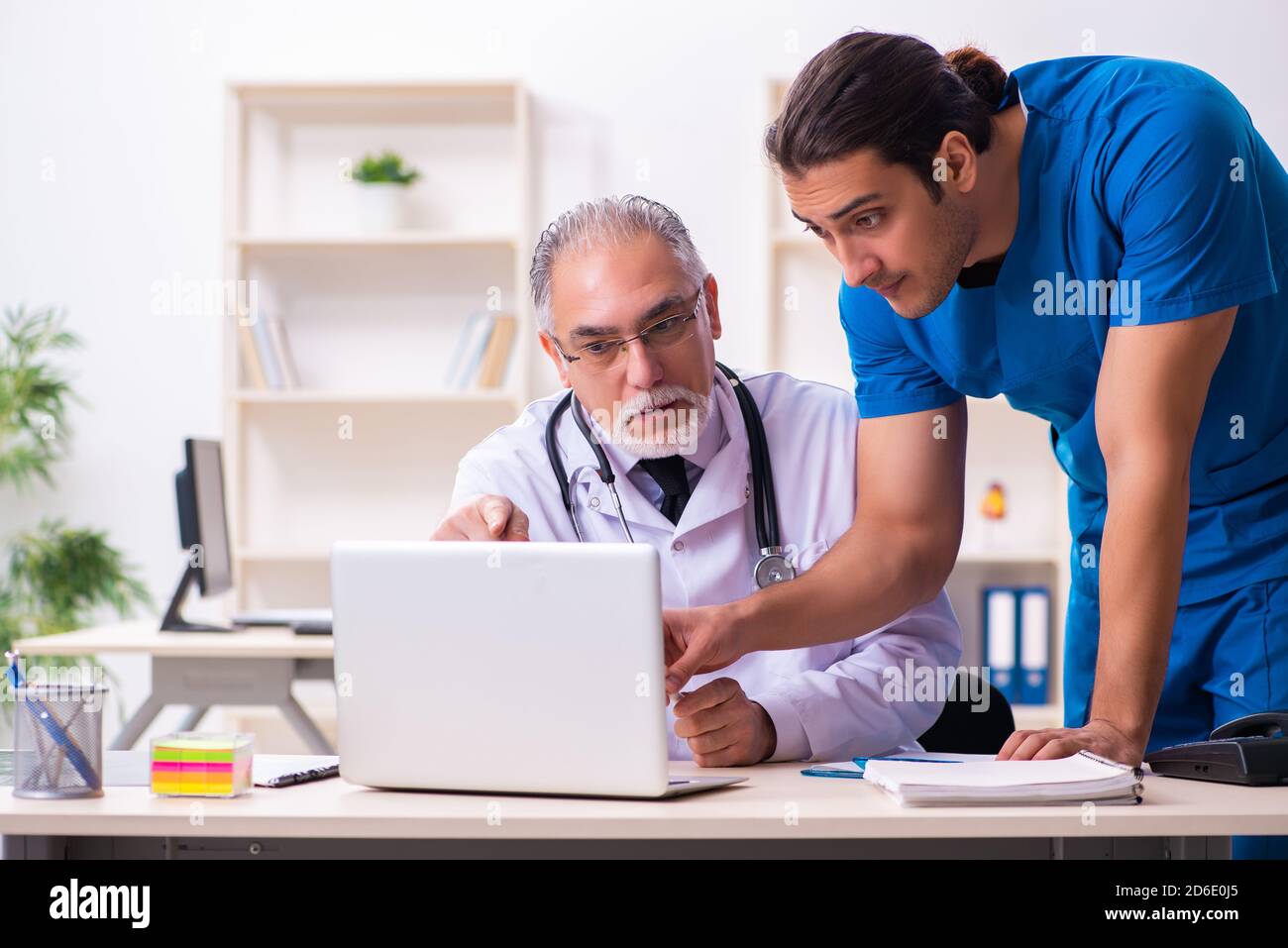 Two male doctors working in the modern clinic Stock Photo - Alamy