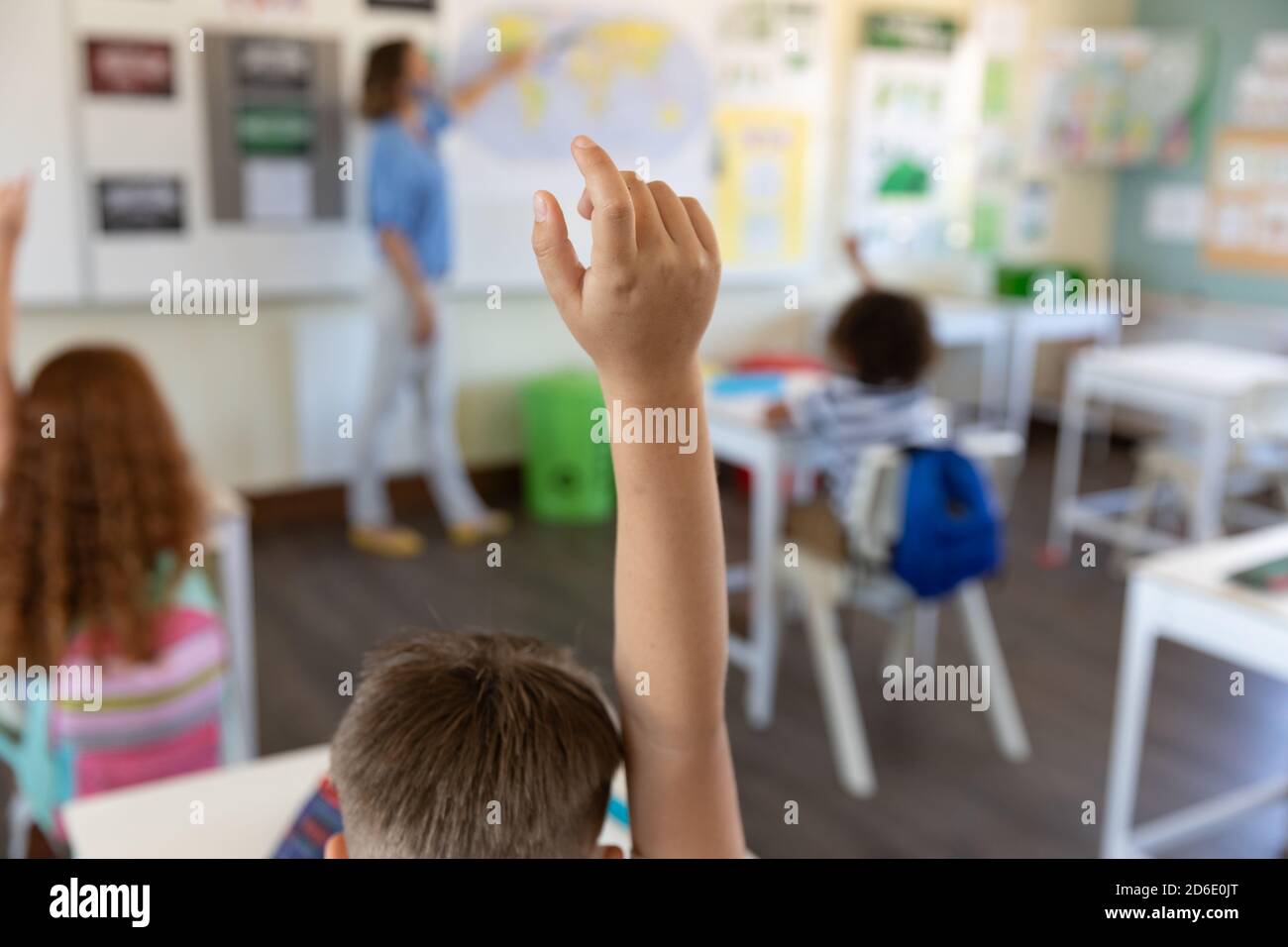 Students raising hands in classroom hi-res stock photography and images ...