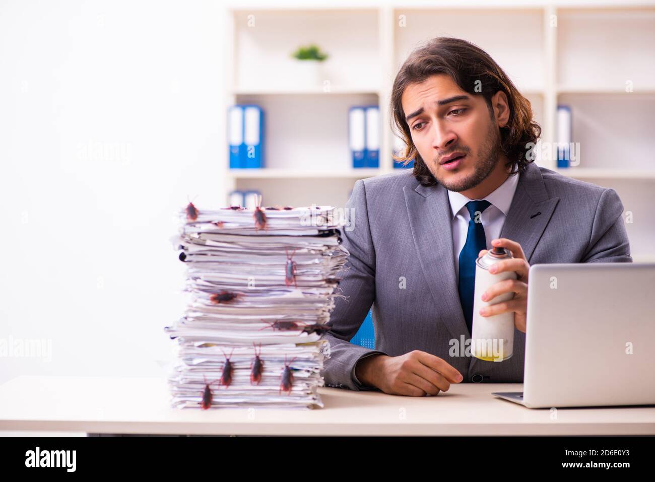 Young employee and too many cockroaches in the office Stock Photo - Alamy