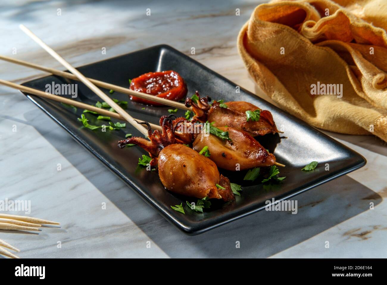 Seafood grilled squid satay kebab skewers with tentacles and sriracha ...