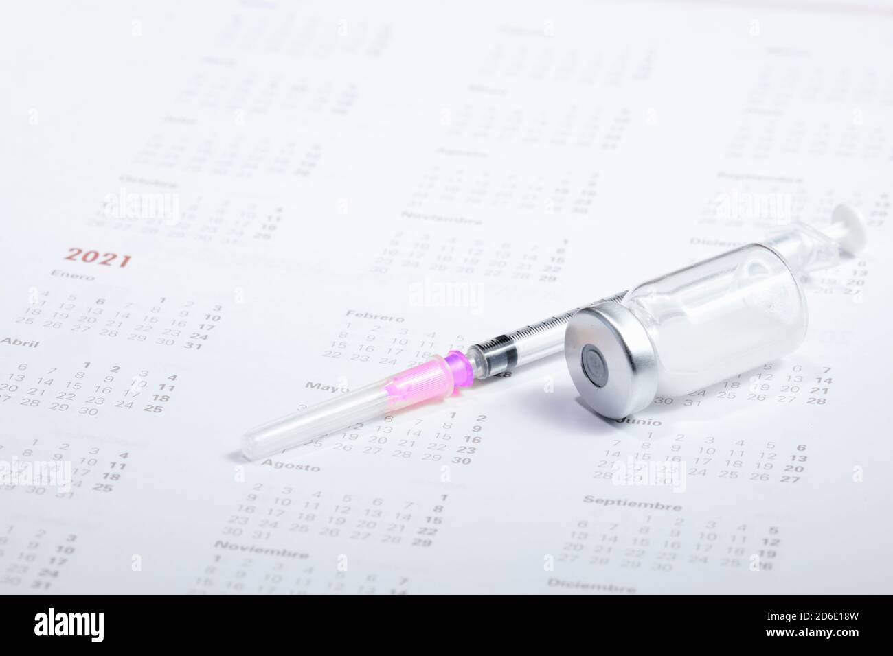 Medical concept. In the calendar, syringe with container of epidemic ...