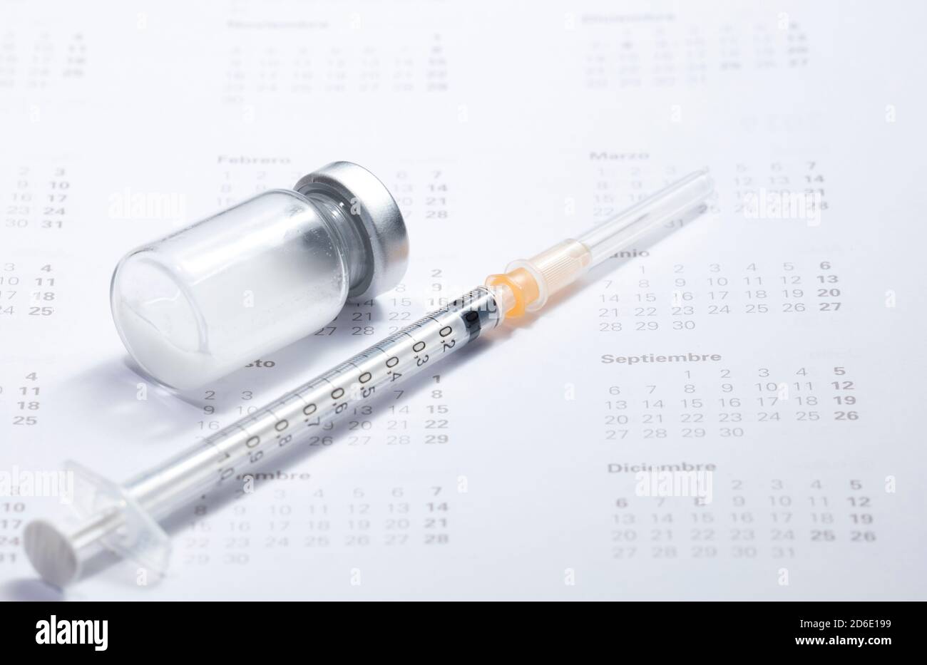 Medical concept. In the calendar, syringe with container of epidemic ...
