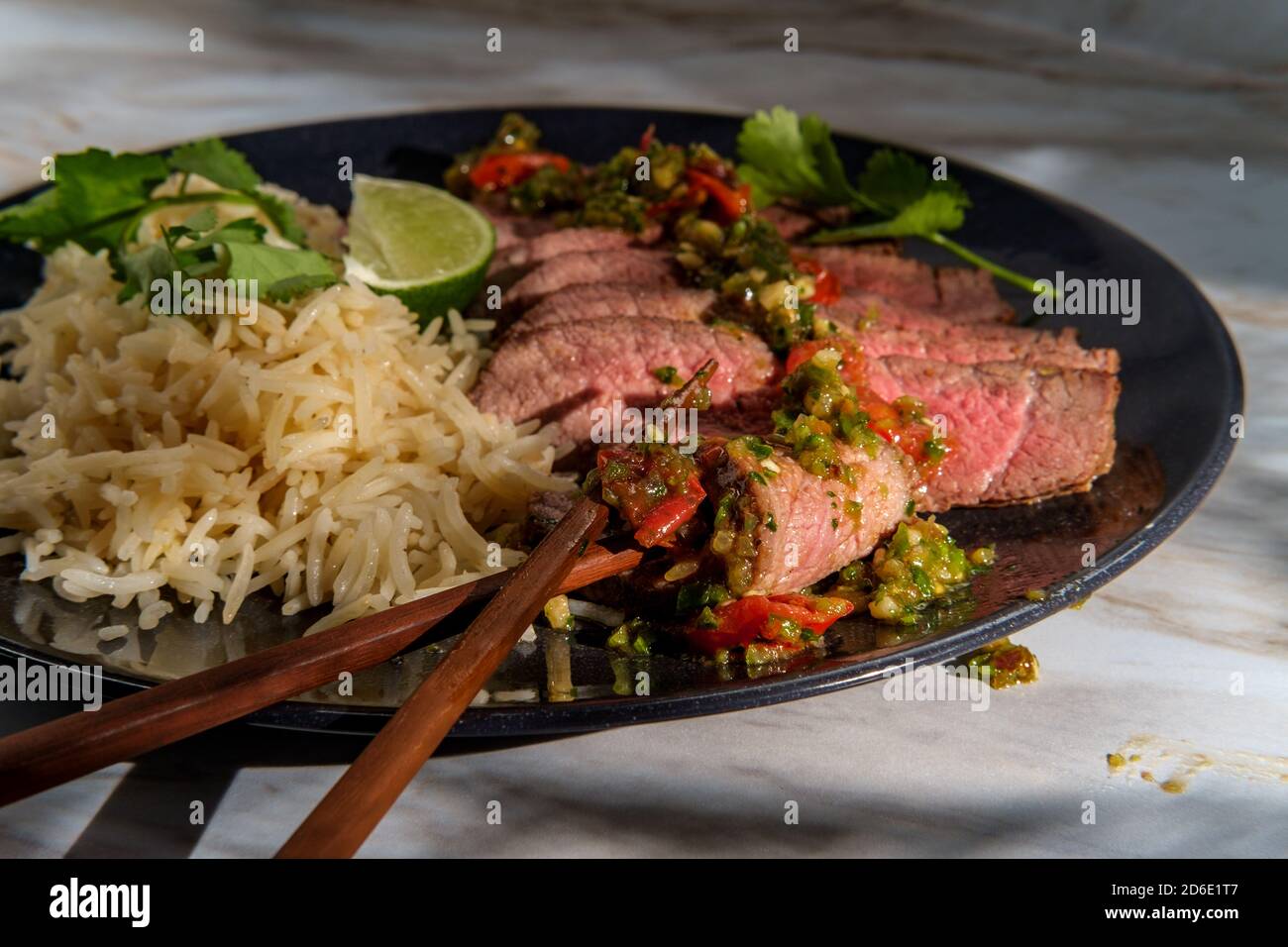 Rib-eye steak cooked rare with hot and spicy Thai crying tiger sauce ...