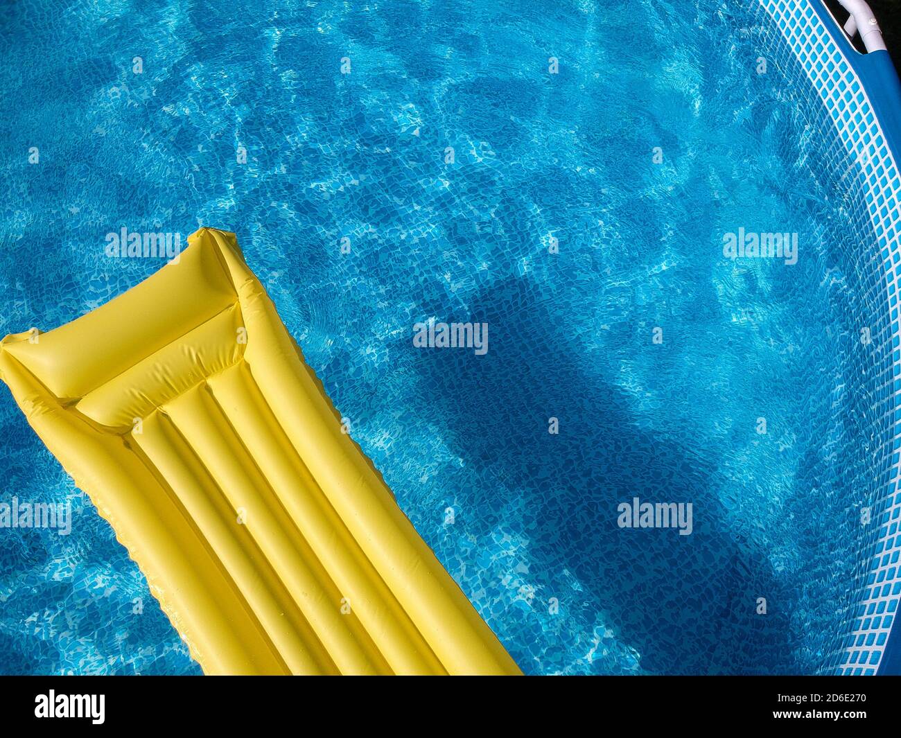 Top view of a yellow inflatable mattress in an above ground private ...