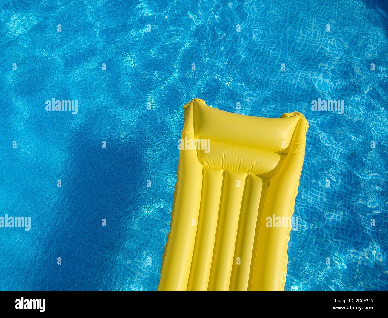 Top view of a yellow inflatable mattress in an above ground private ...