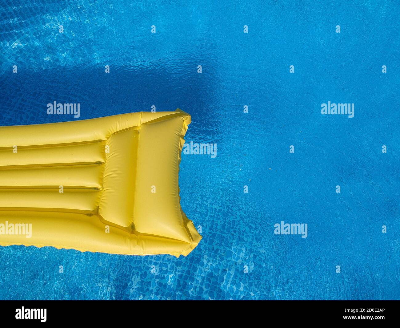 Top view of a yellow inflatable mattress in an above ground private ...