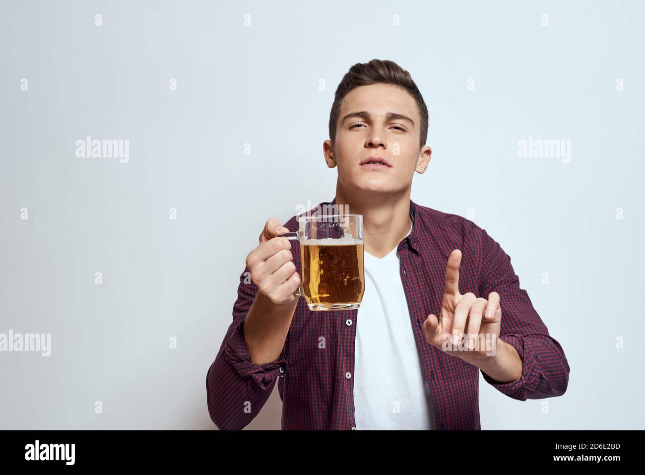 Drunk man with a mug of beer vacation alcohol lifestyle in a red shirt ...