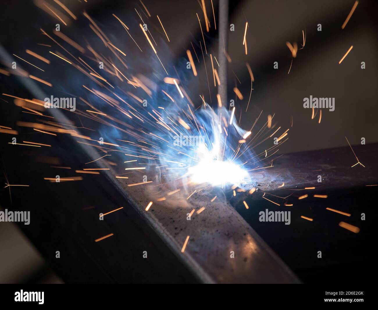 Close-up of electric welding spot producing high temperature and sparks ...