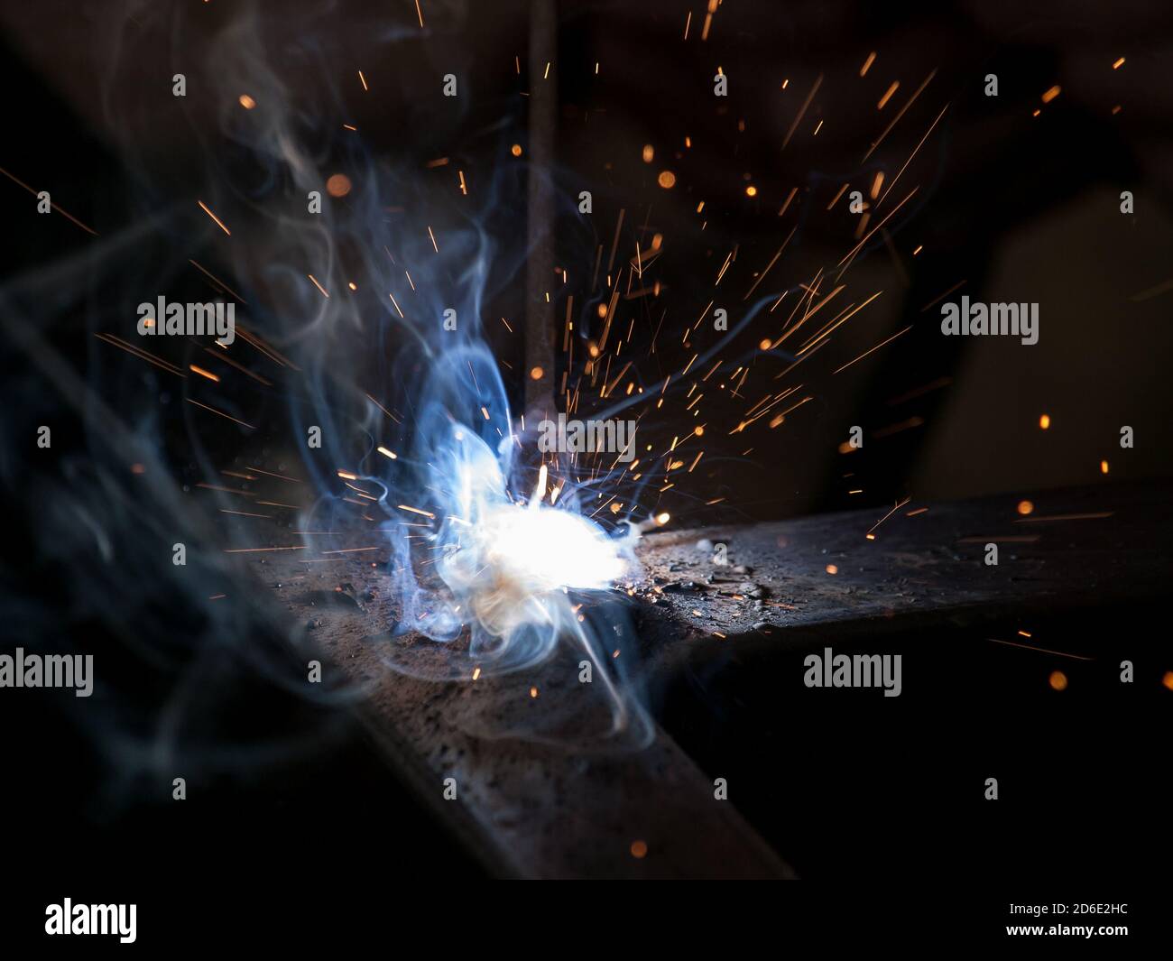 Close-up of electric welding spot producing high temperature and sparks ...