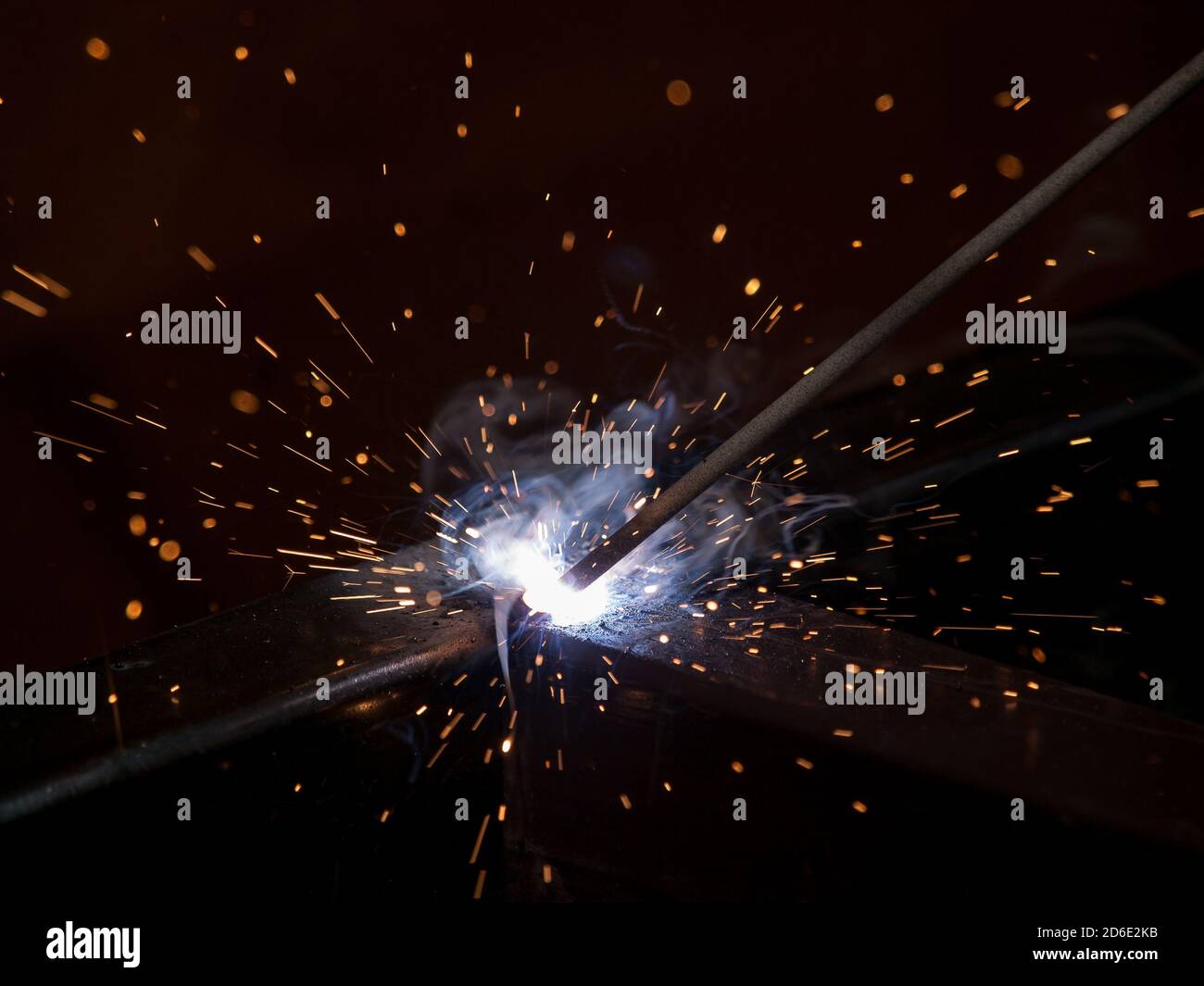 Close-up of electric welding spot producing high temperature and sparks ...
