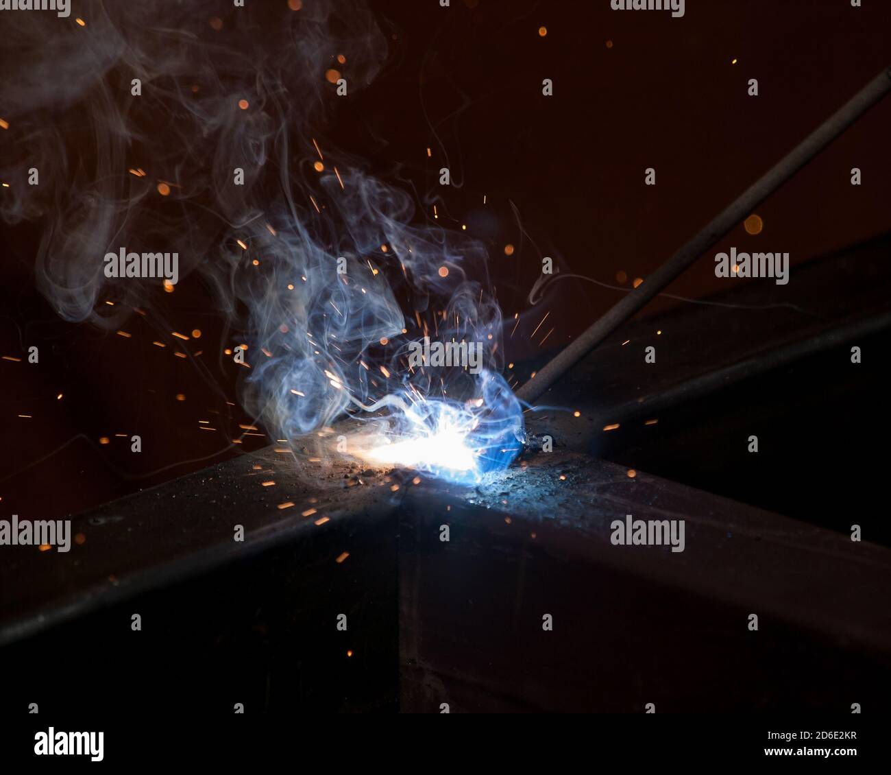 Close-up of electric welding spot producing high temperature and sparks ...