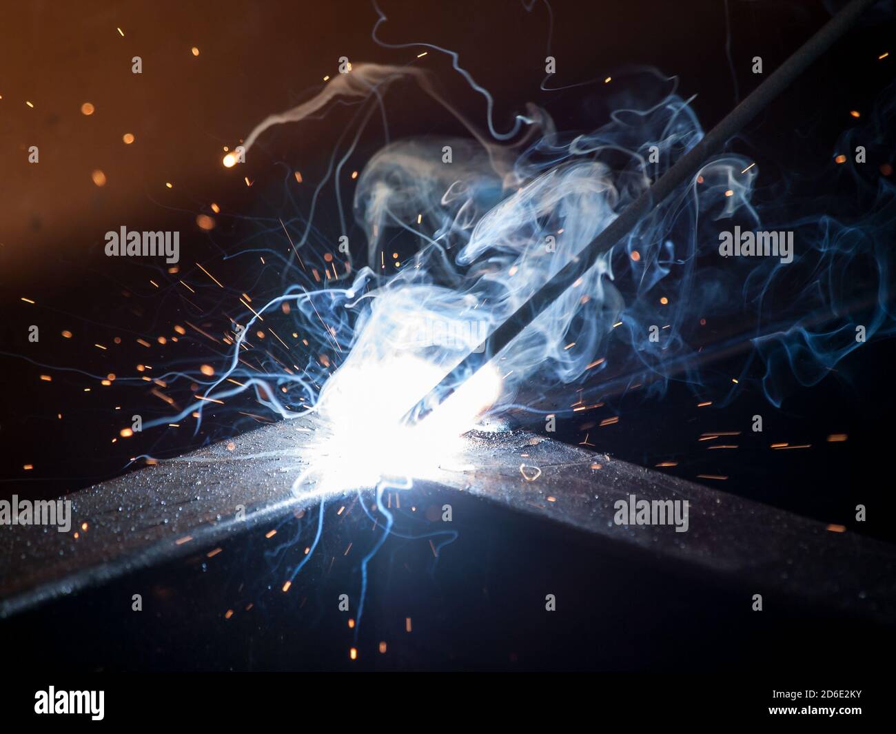 Close-up of electric welding spot producing high temperature and sparks ...