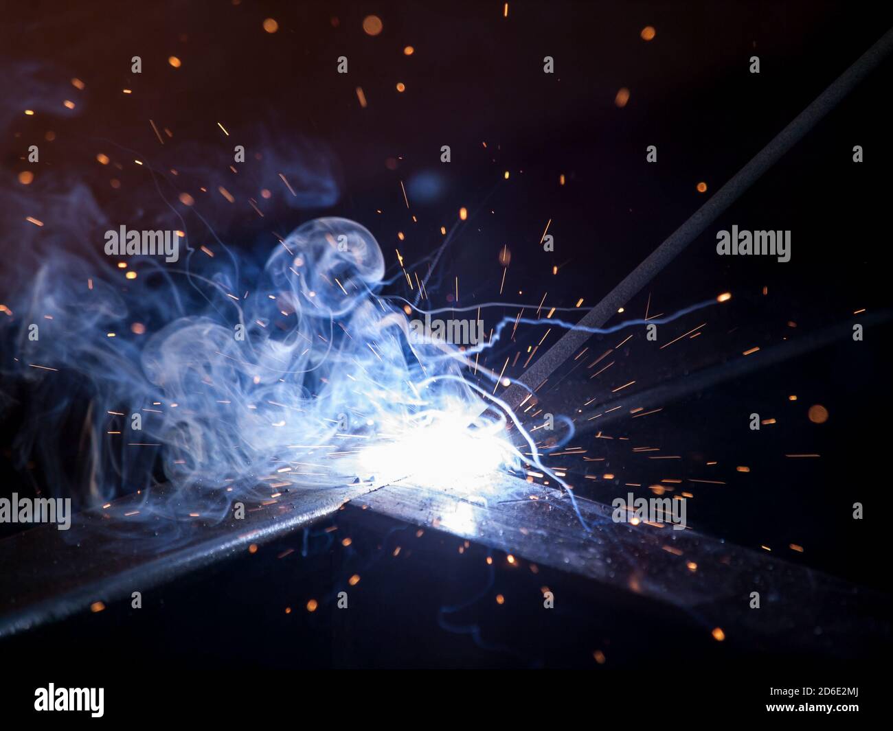 Close-up of electric welding spot producing high temperature and sparks ...