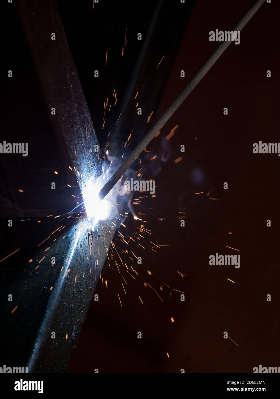 Close-up of electric welding spot producing high temperature and sparks ...