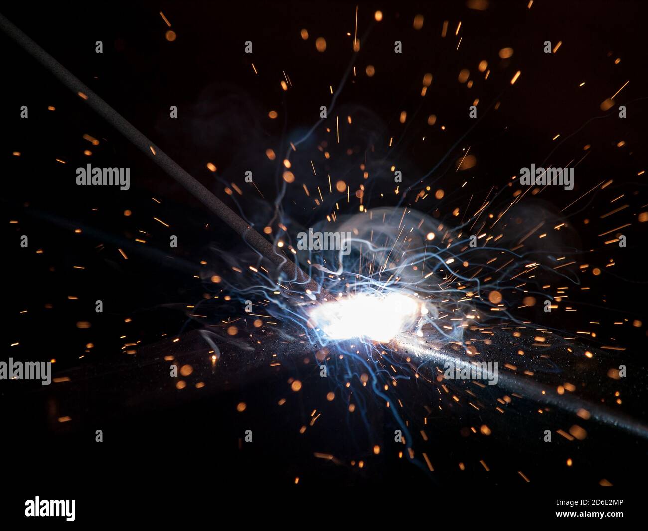 Close-up of electric welding spot producing high temperature and sparks ...