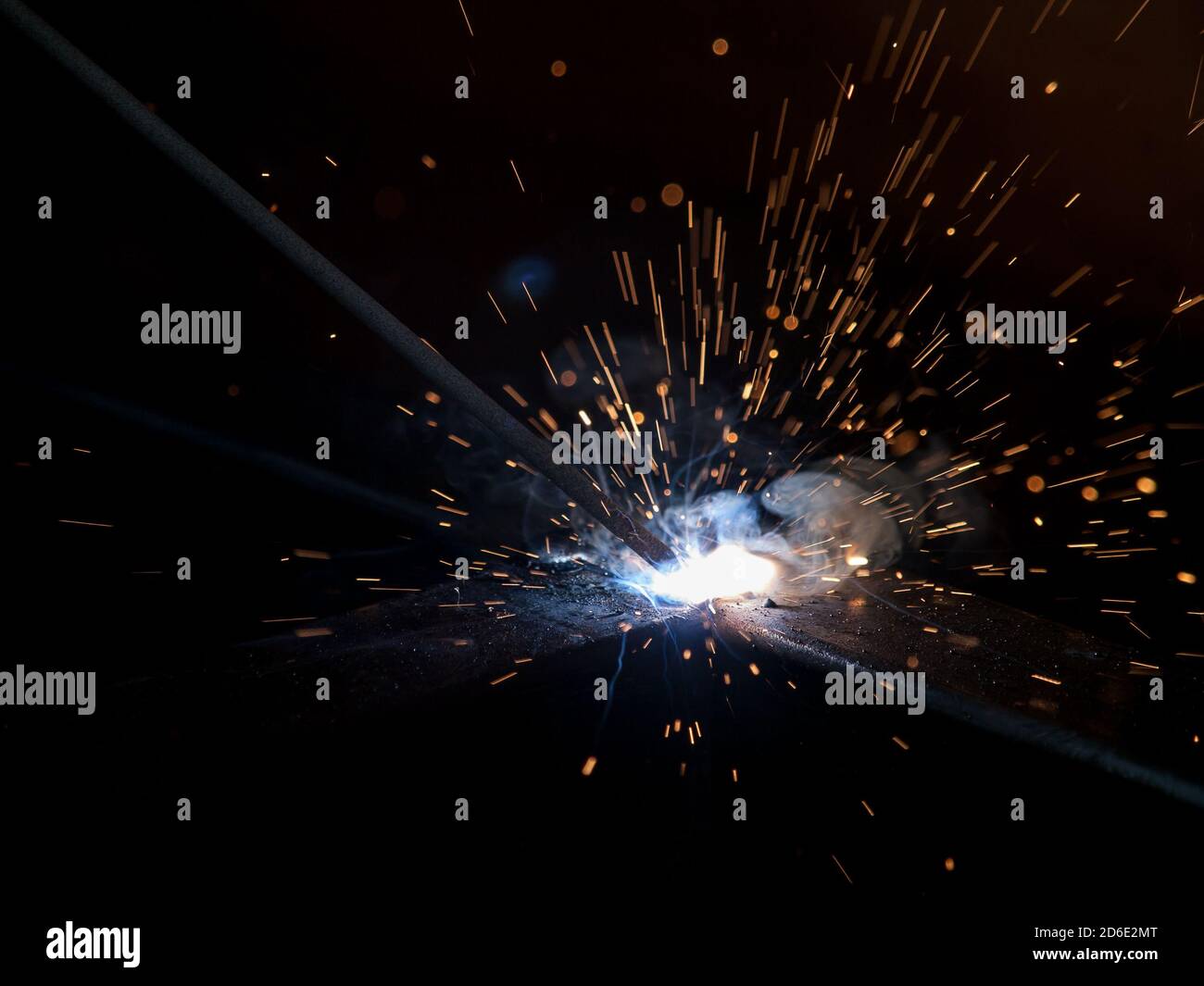 Close-up of electric welding spot producing high temperature and sparks ...