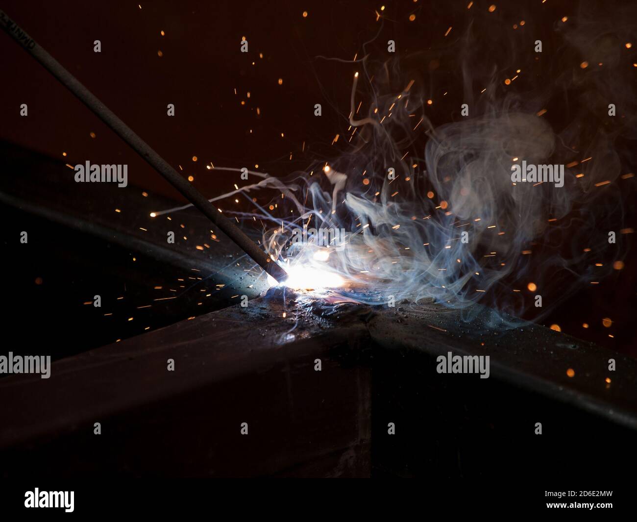 Close-up of electric welding spot producing high temperature and sparks ...