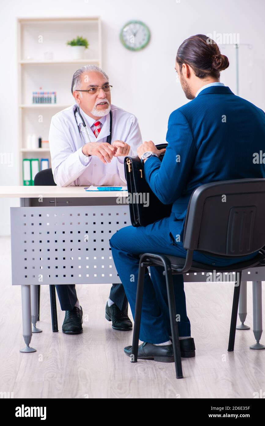 Doctor and businessman discussing medical project Stock Photo - Alamy