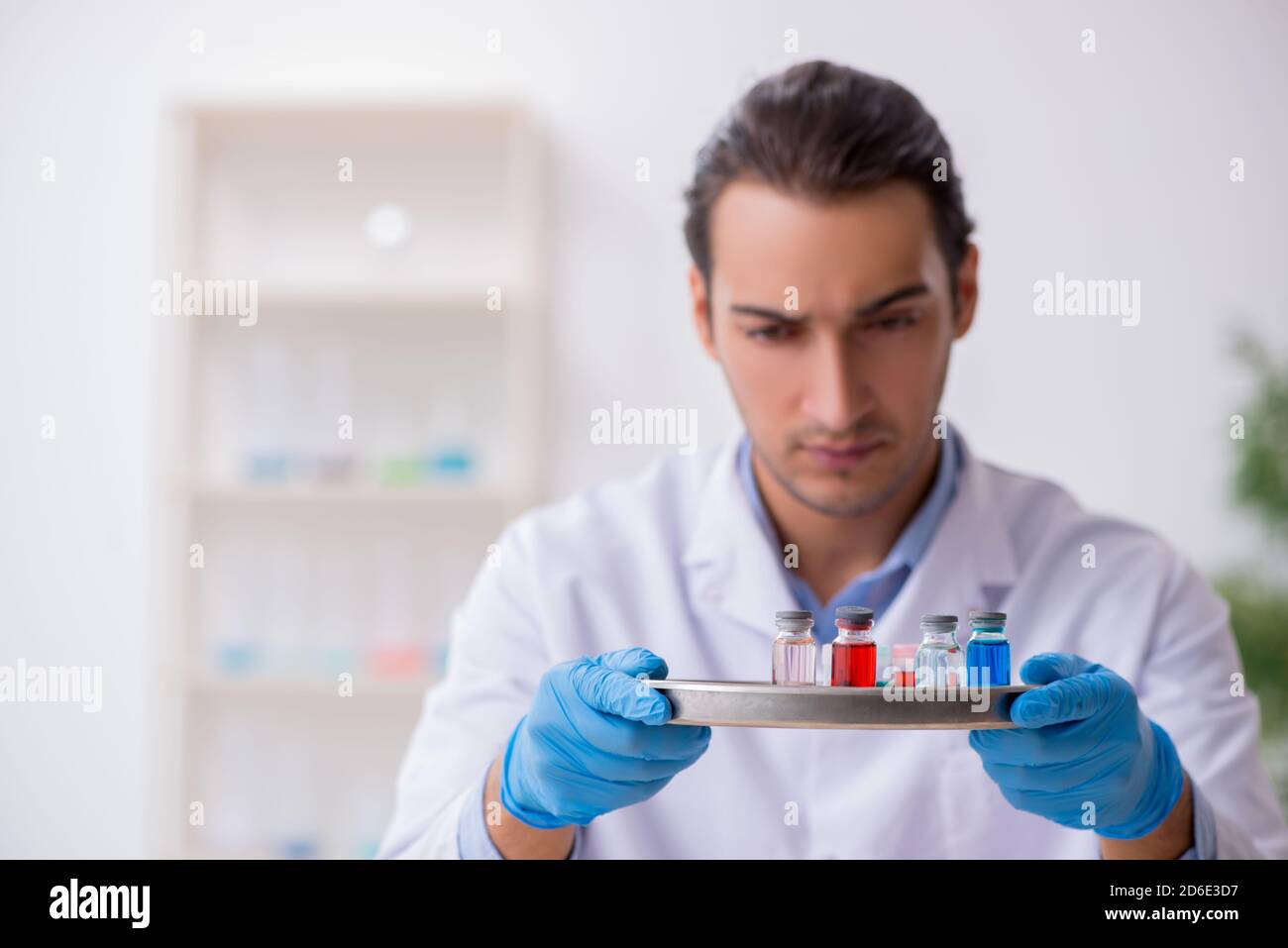 Young male lab assistant in the drug synthesis concept Stock Photo - Alamy