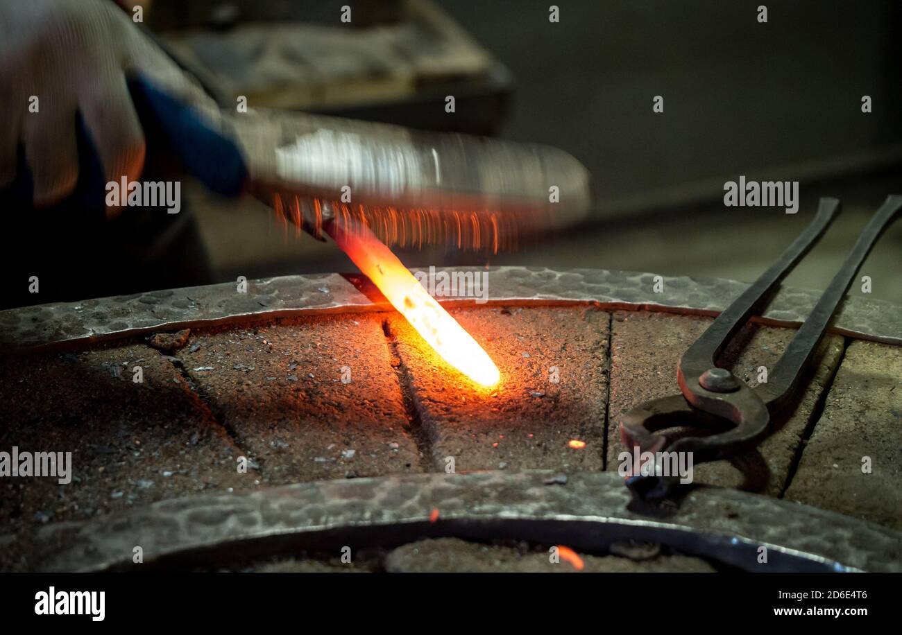 Rod of red hot forging steel at the blacksmith's Stock Photo - Alamy